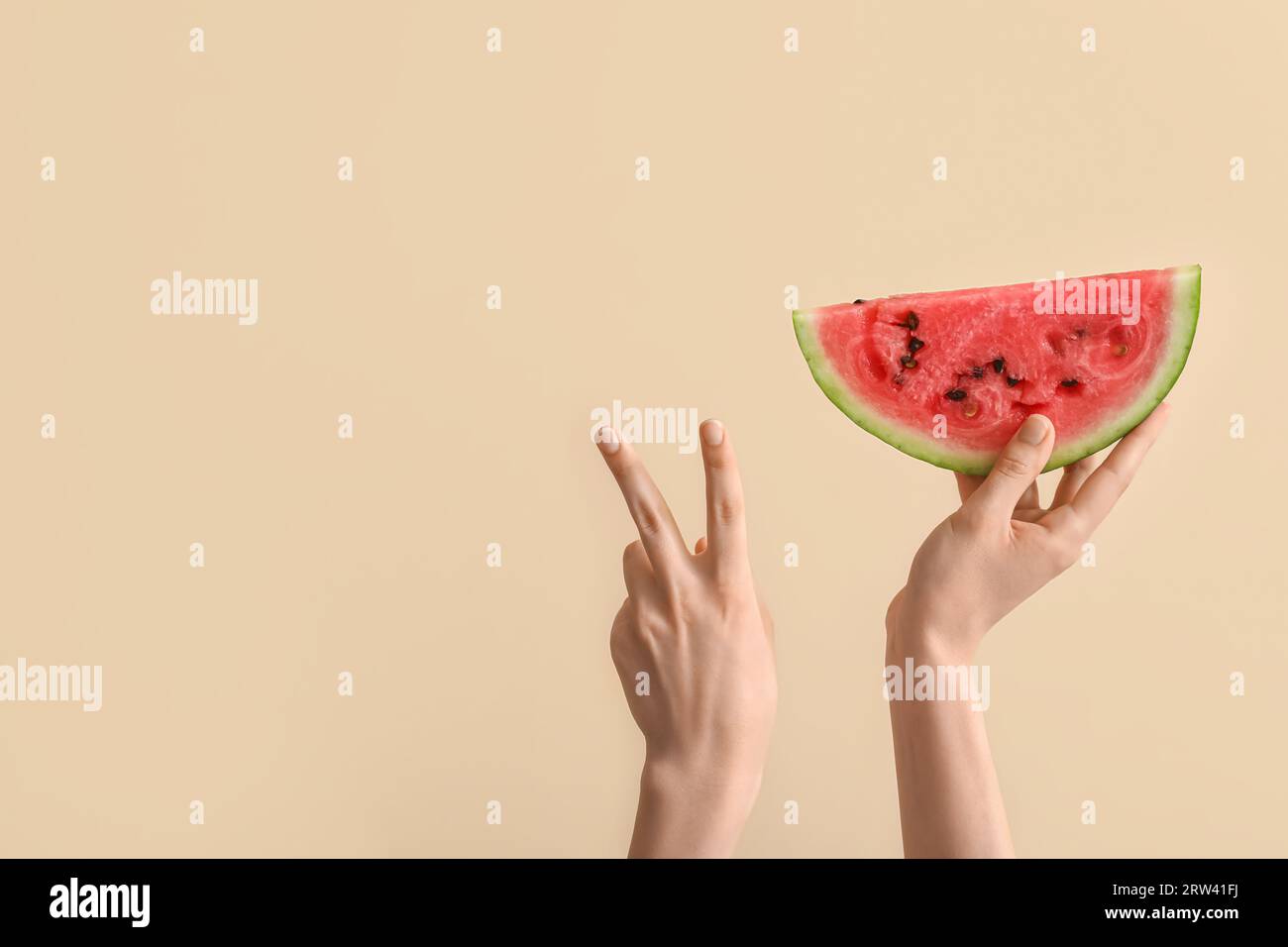 Female hands with slice of ripe watermelon on beige background Stock ...