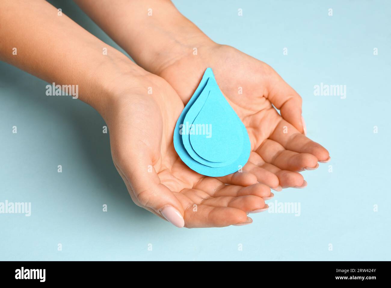 Female hands with paper drops on blue background. World Polio Day Stock ...