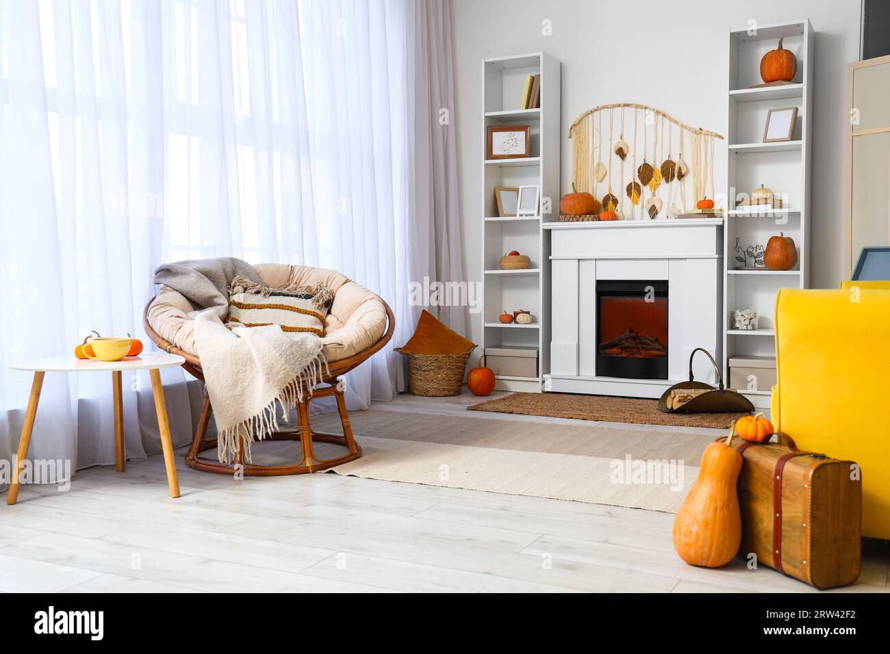 Interior of living room with pumpkins, fireplace and shelf units Stock ...