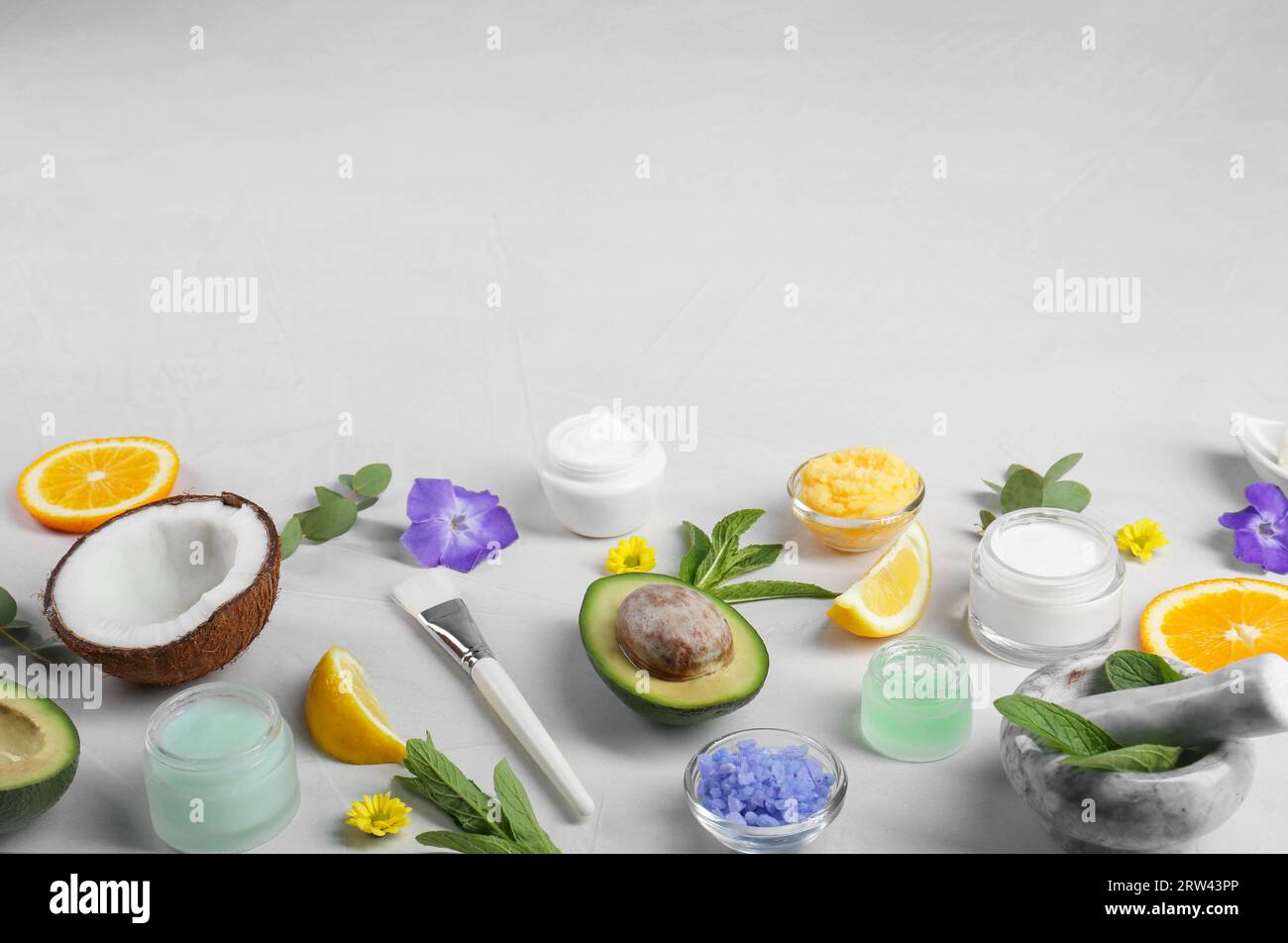 Homemade cosmetic products and fresh ingredients on light grey ...