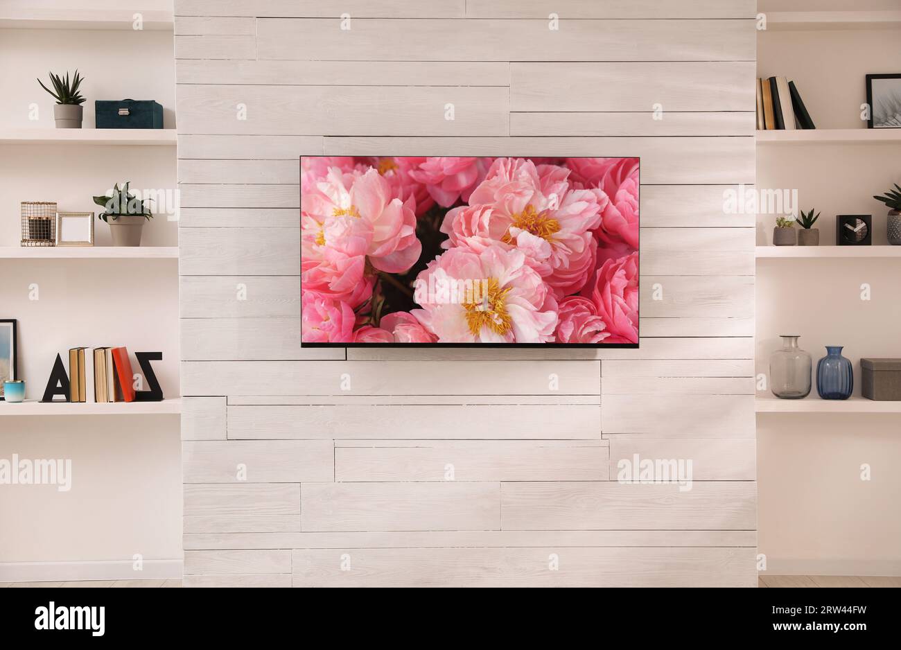 Beautiful peony flowers on TV screen in room Stock Photo - Alamy