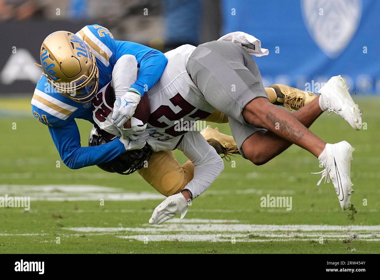UCLA defensive back Isaiah Newcombe, left, tackles North Carolina ...