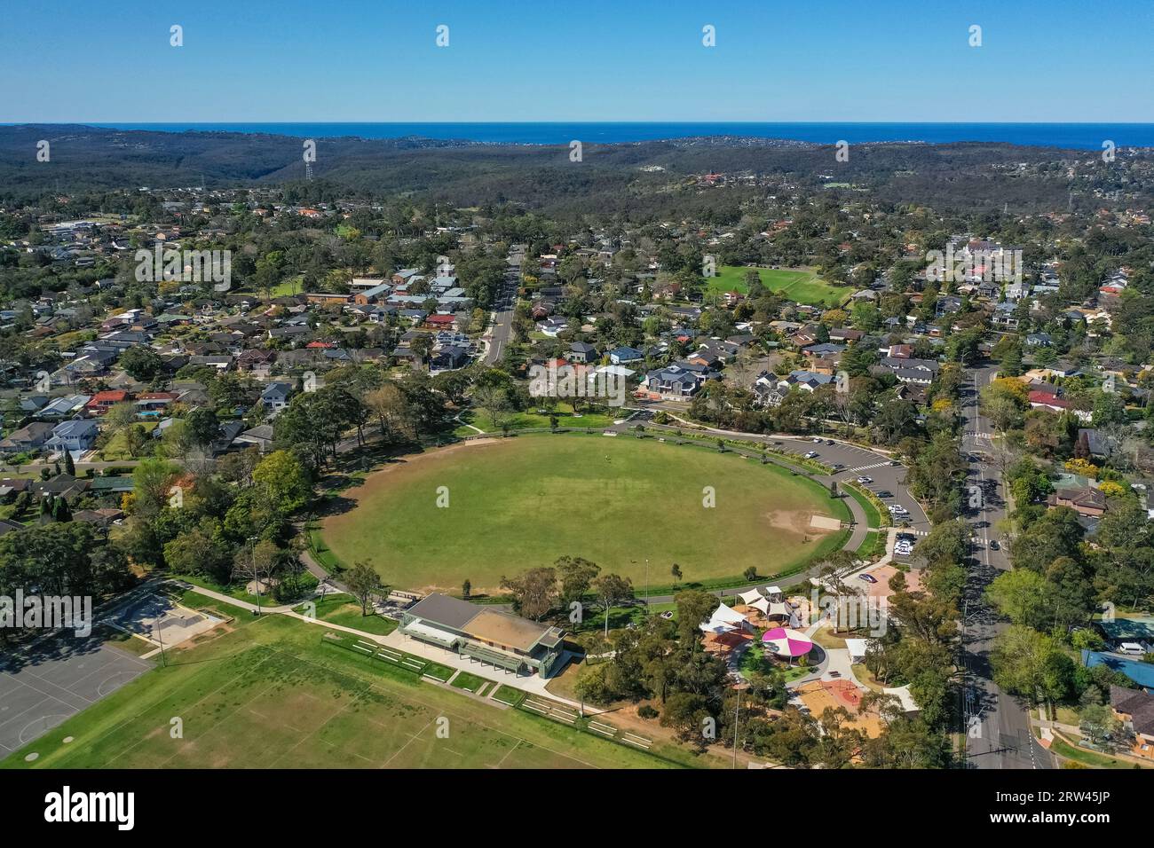 Aerial, drone photo of round dog park with car park, in suburbs of ...