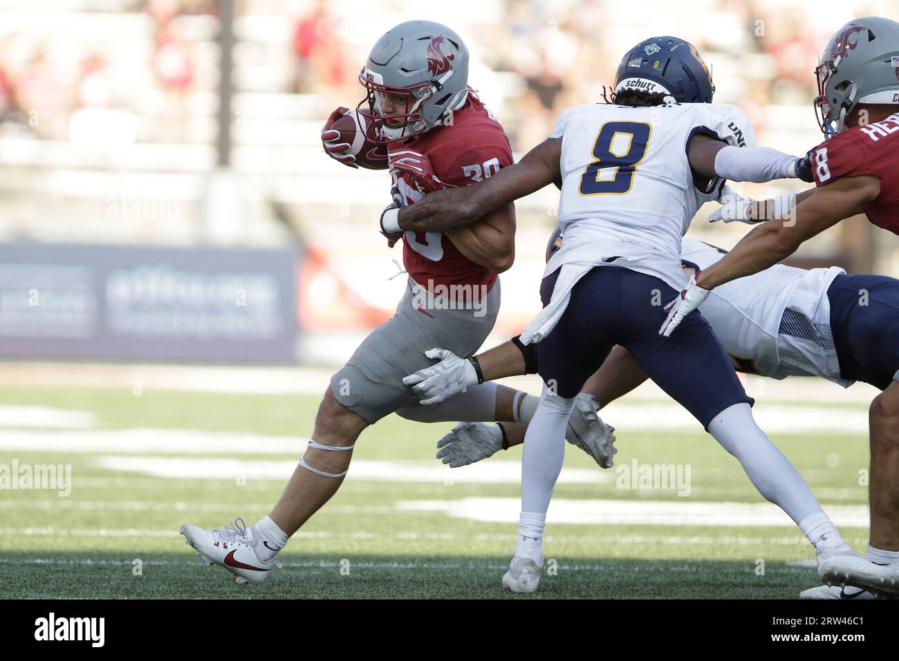 Washington State running back Dylan Paine, left, carries the ball while ...