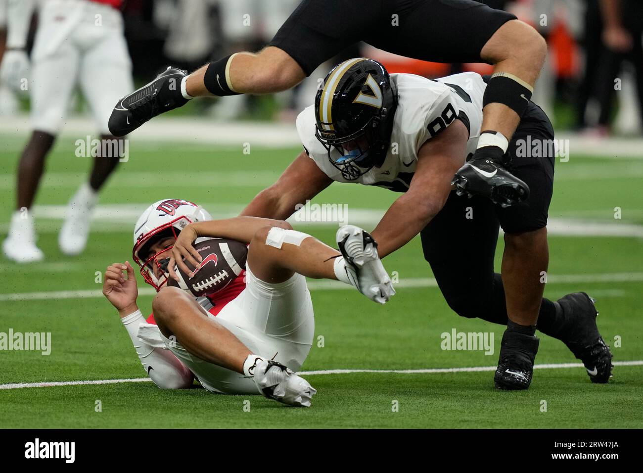 Vanderbilt defensive lineman Devin Lee (99) tackles UNLV quarterback ...
