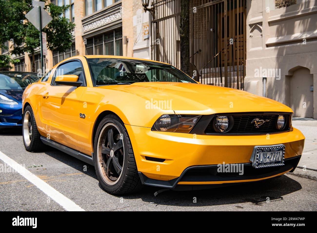 New York City, USA - August 05, 2023: 2011 Ford Mustang V6 yellow car ...