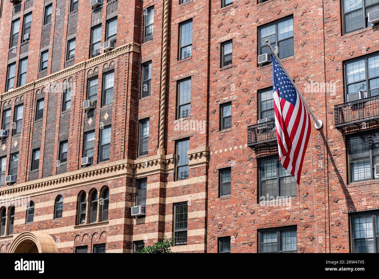 american flag on brick brownstone building. architectural exterior and ...