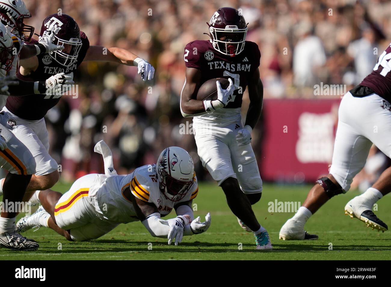 Texas A&M running back Rueben Owens (2) steps out of a tackle by ...