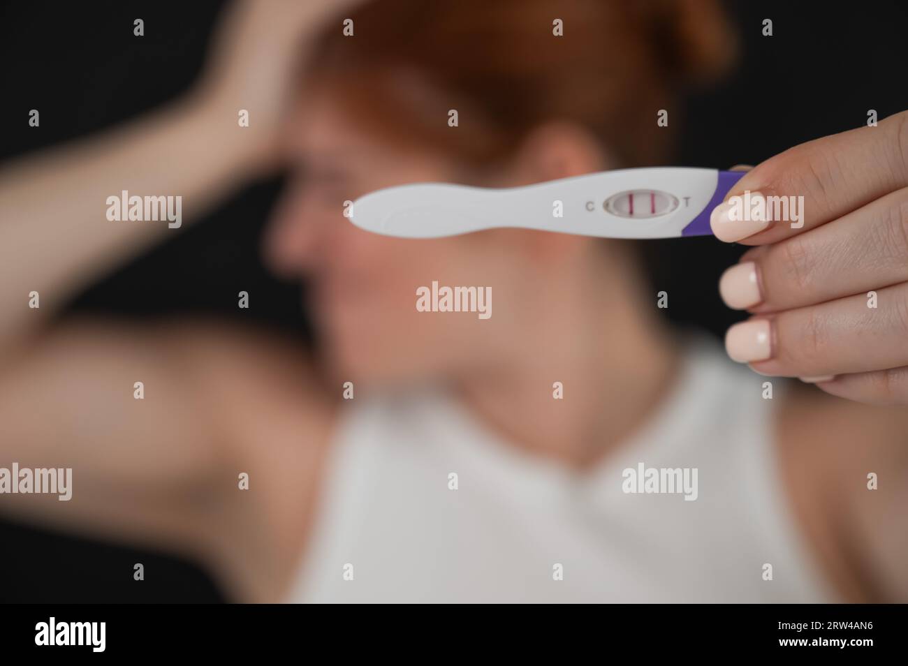 Blurred portrait of upset caucasian woman holding positive rapid ... Blurred portrait of upset caucasian woman holding positive rapid ...