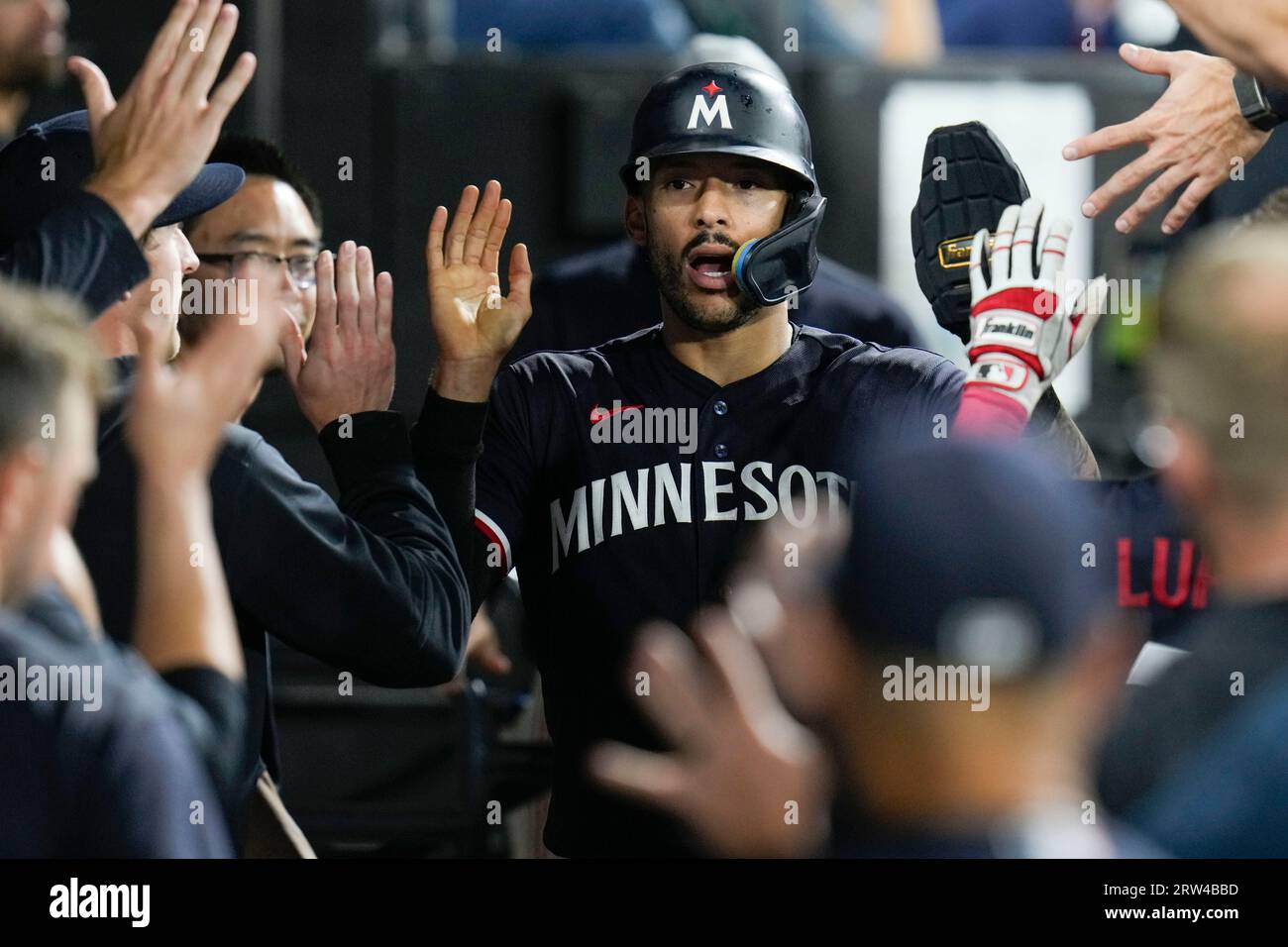 Minnesota Twins' Carlos Correa celebrates in the dugout after scoring ...