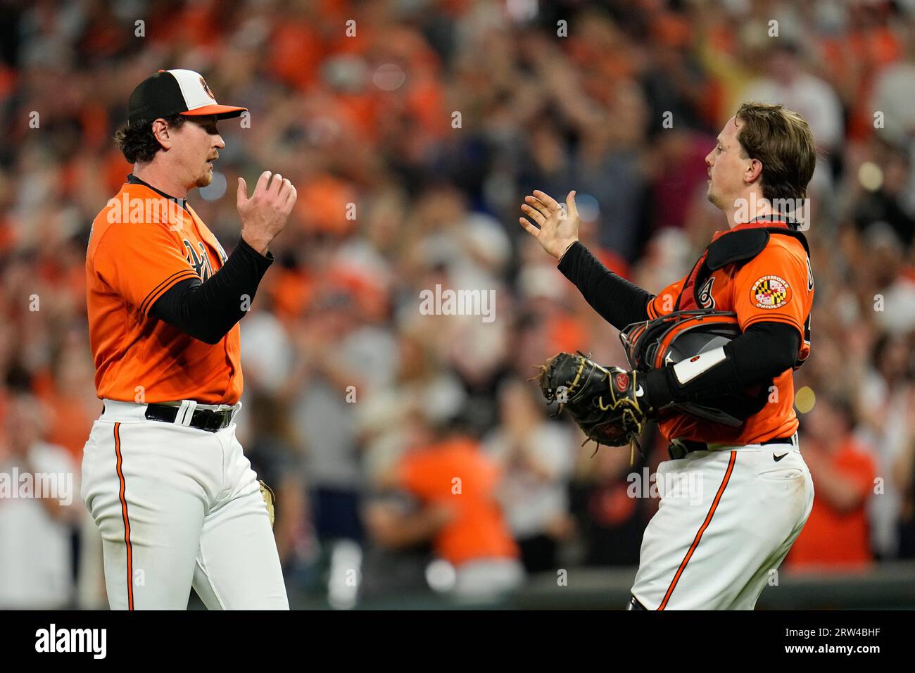 Baltimore Orioles relief pitcher Mike Baumann, left, reacts with ...