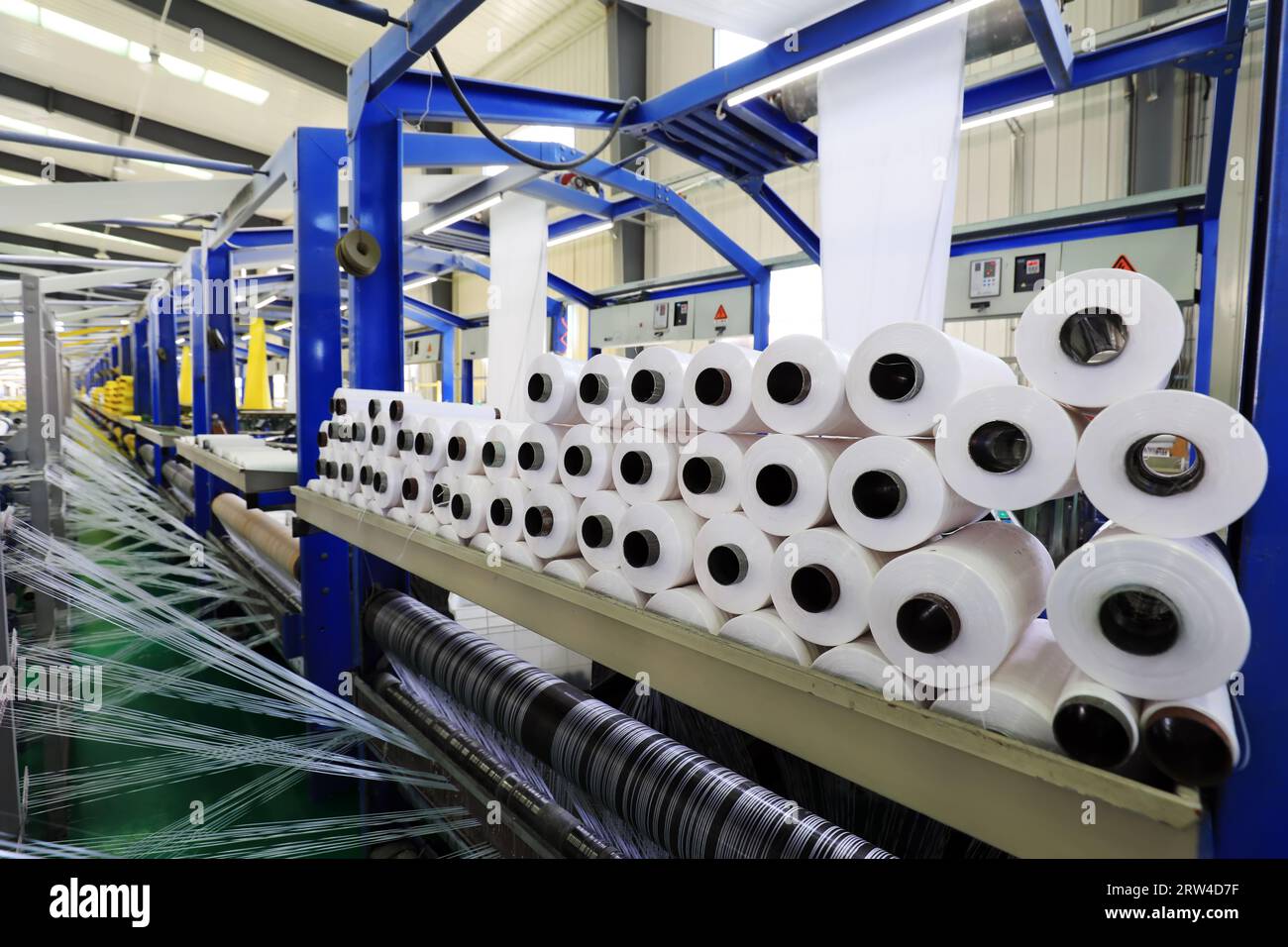 Bobbin in the packaging products processing line in a factory, North ...