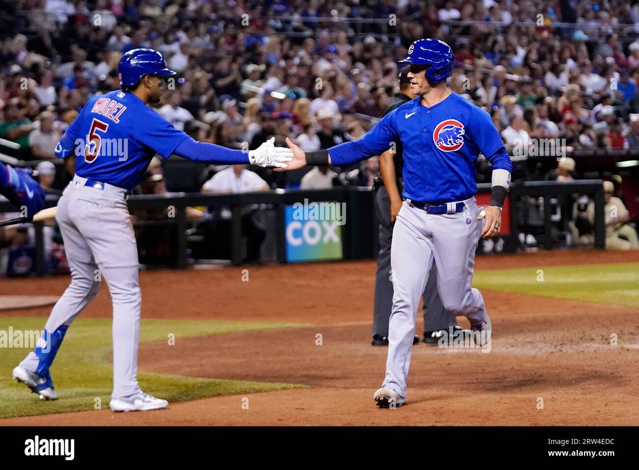 Chicago Cubs' Yan Gomes, right, celebrates his run scored against the ...