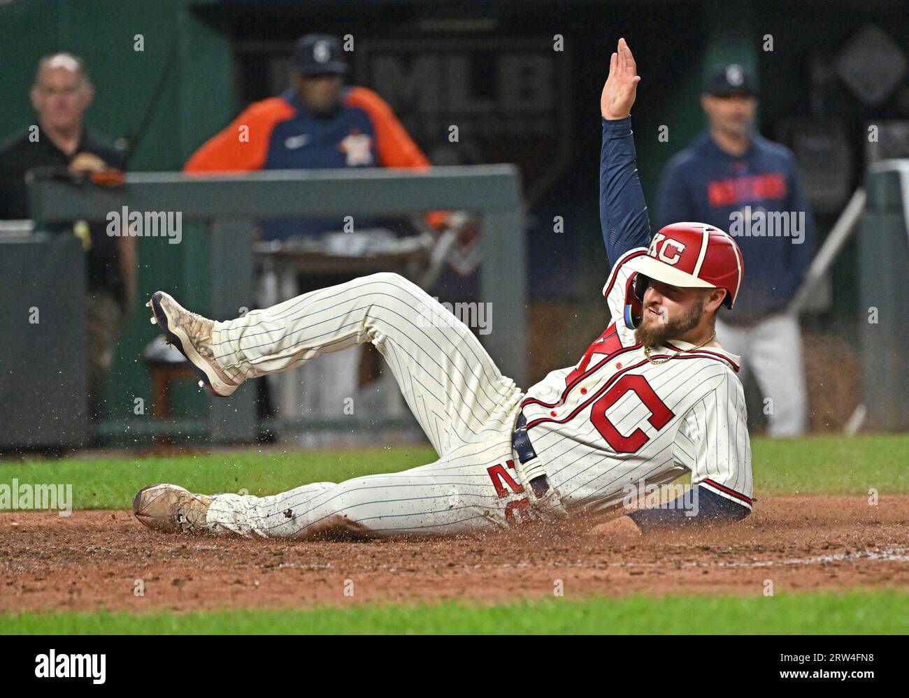 Kansas City Royals' Kyle Isbel slides across home plate to score during ...