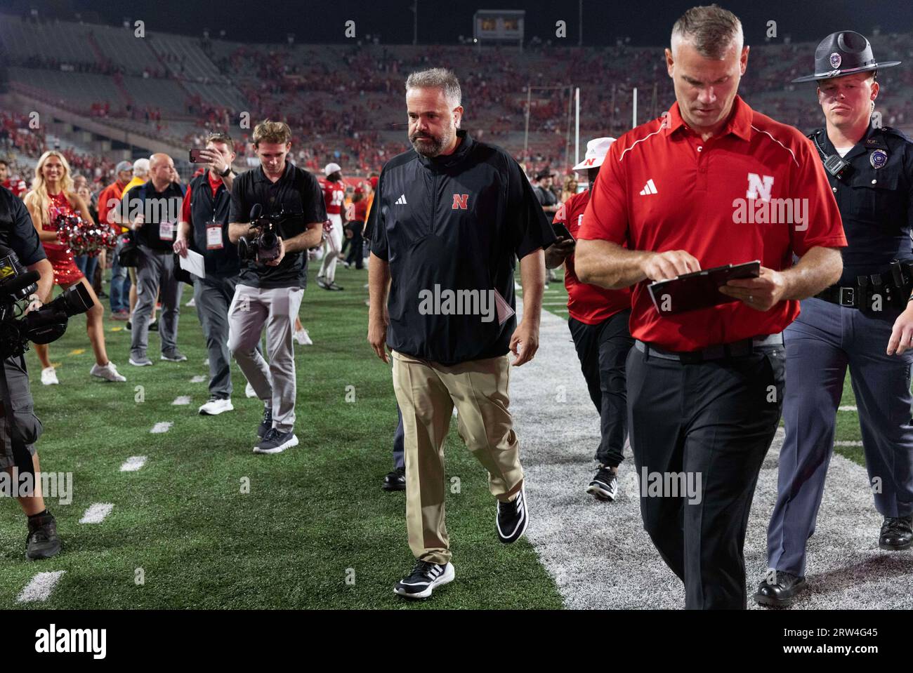 Nebraska head coach Matt Rhule, center, exits the field following his ...
