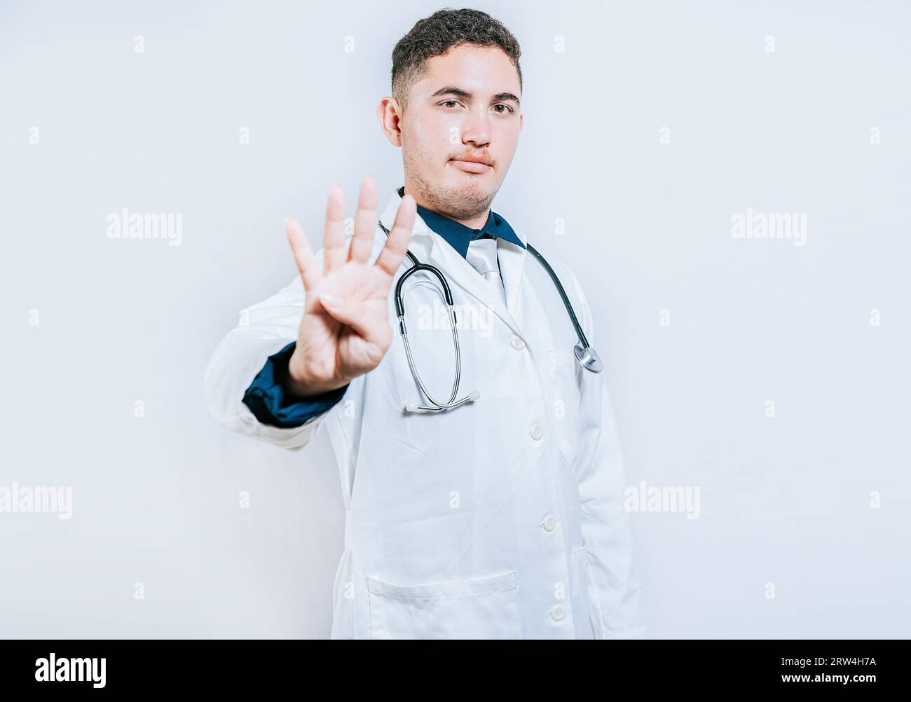 Handsome doctor counting number 4 on isolated background. Doctor ...