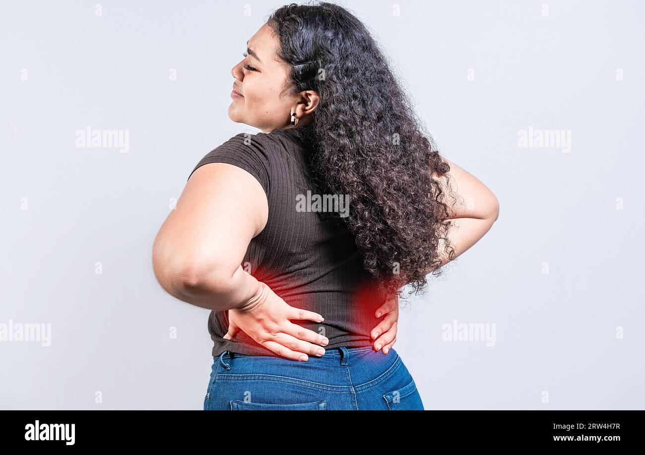 Woman with back pain on isolated background. lumbar problems concept ...