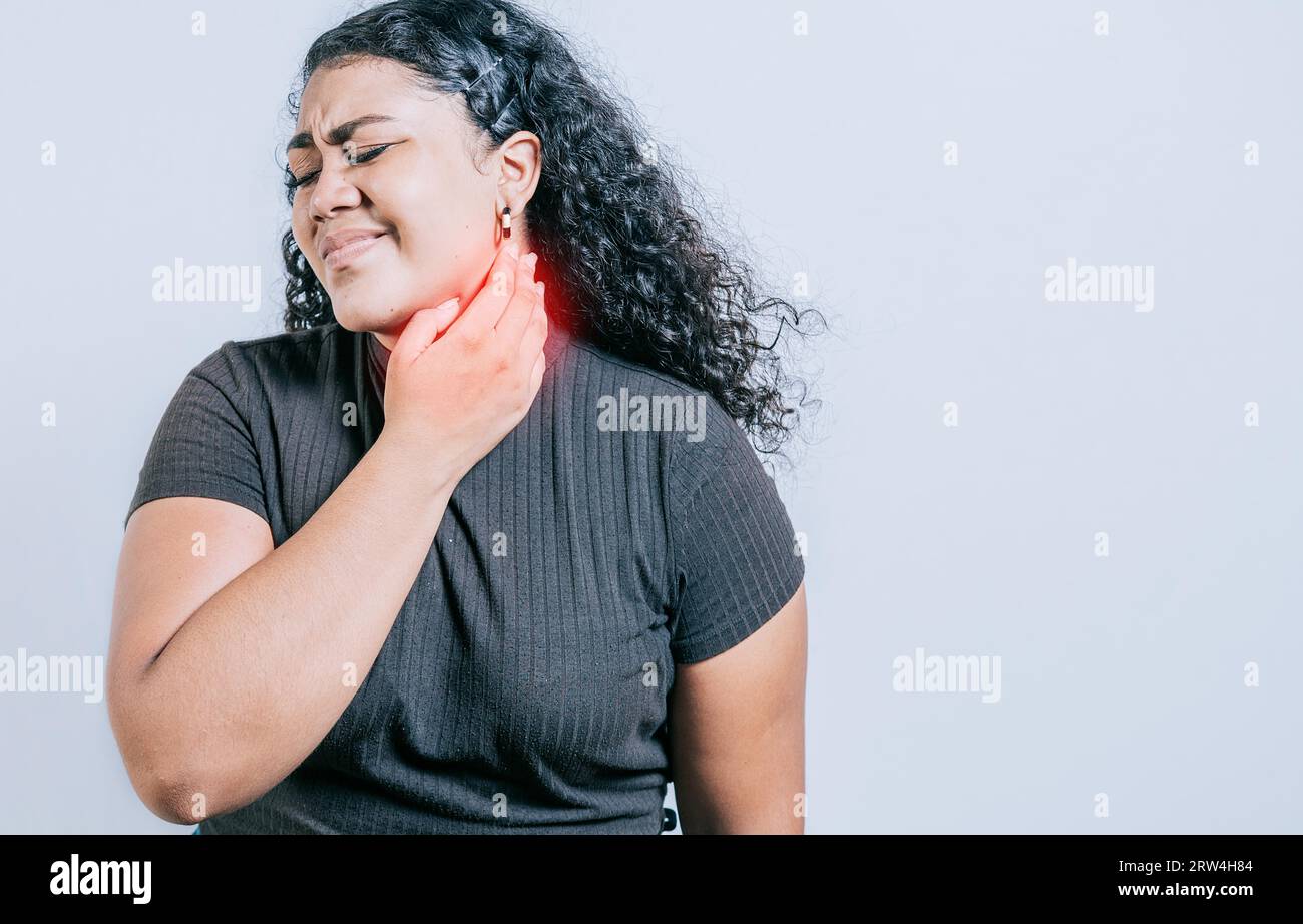 Young woman suffering with neck pain. Neck pain and stress concept ...