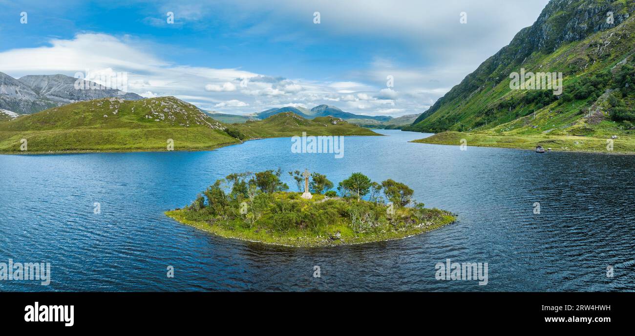 Aerial panorama of a small island with a Celtic stone cross in the ...