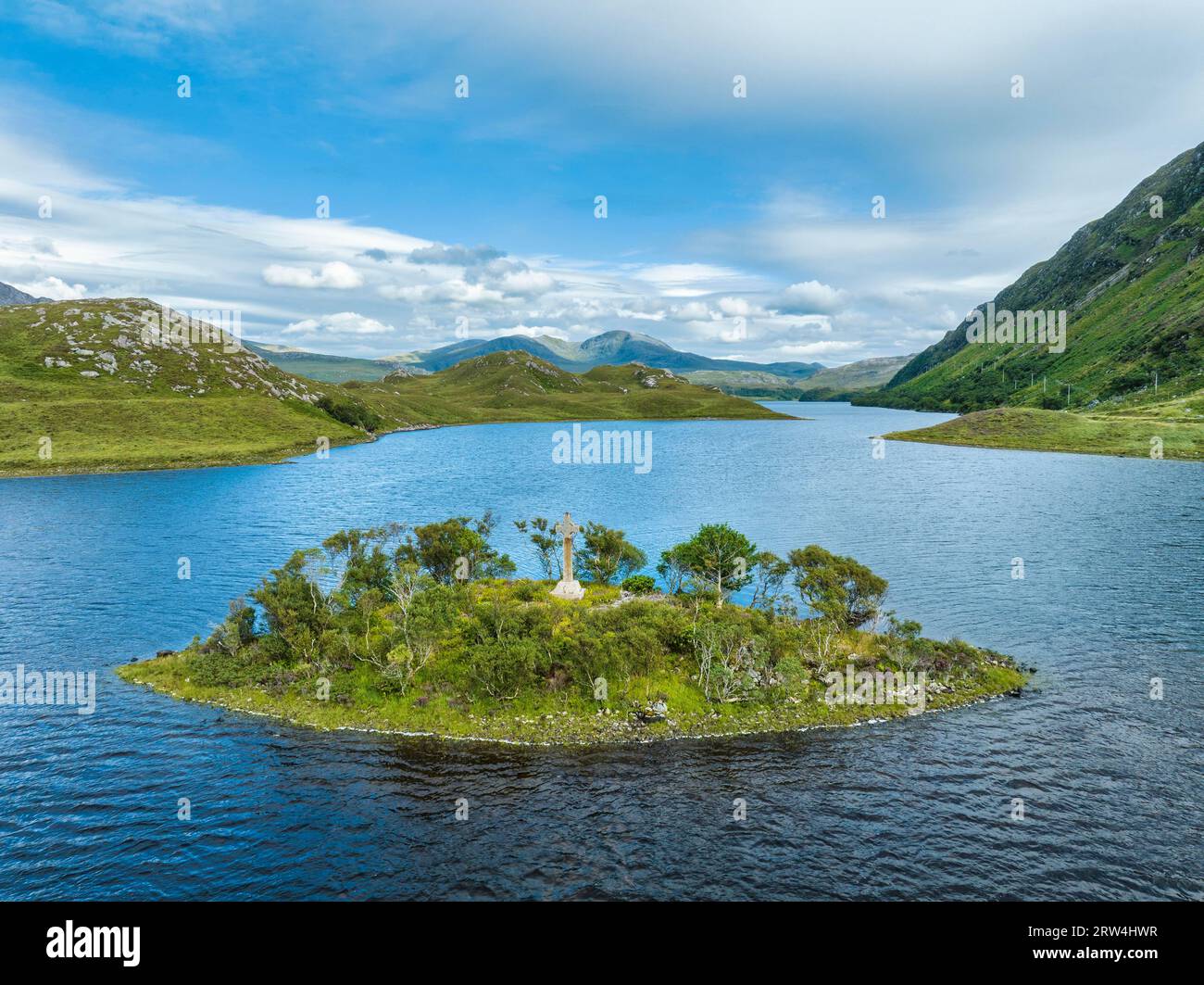 Aerial view of a small island with a Celtic stone cross in the ...