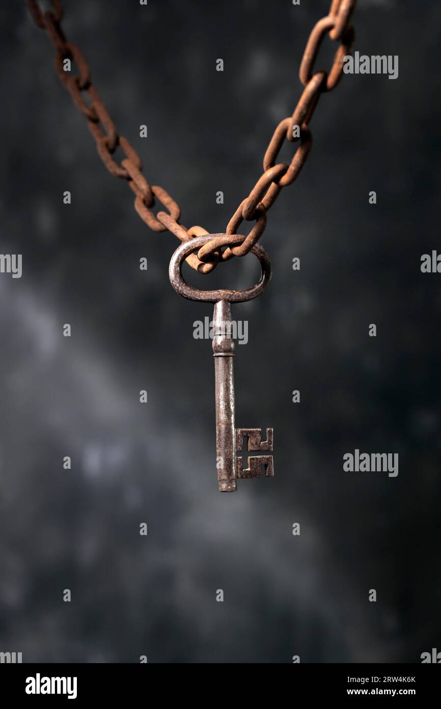 Old big key hanging from a rusty chain Stock Photo - Alamy