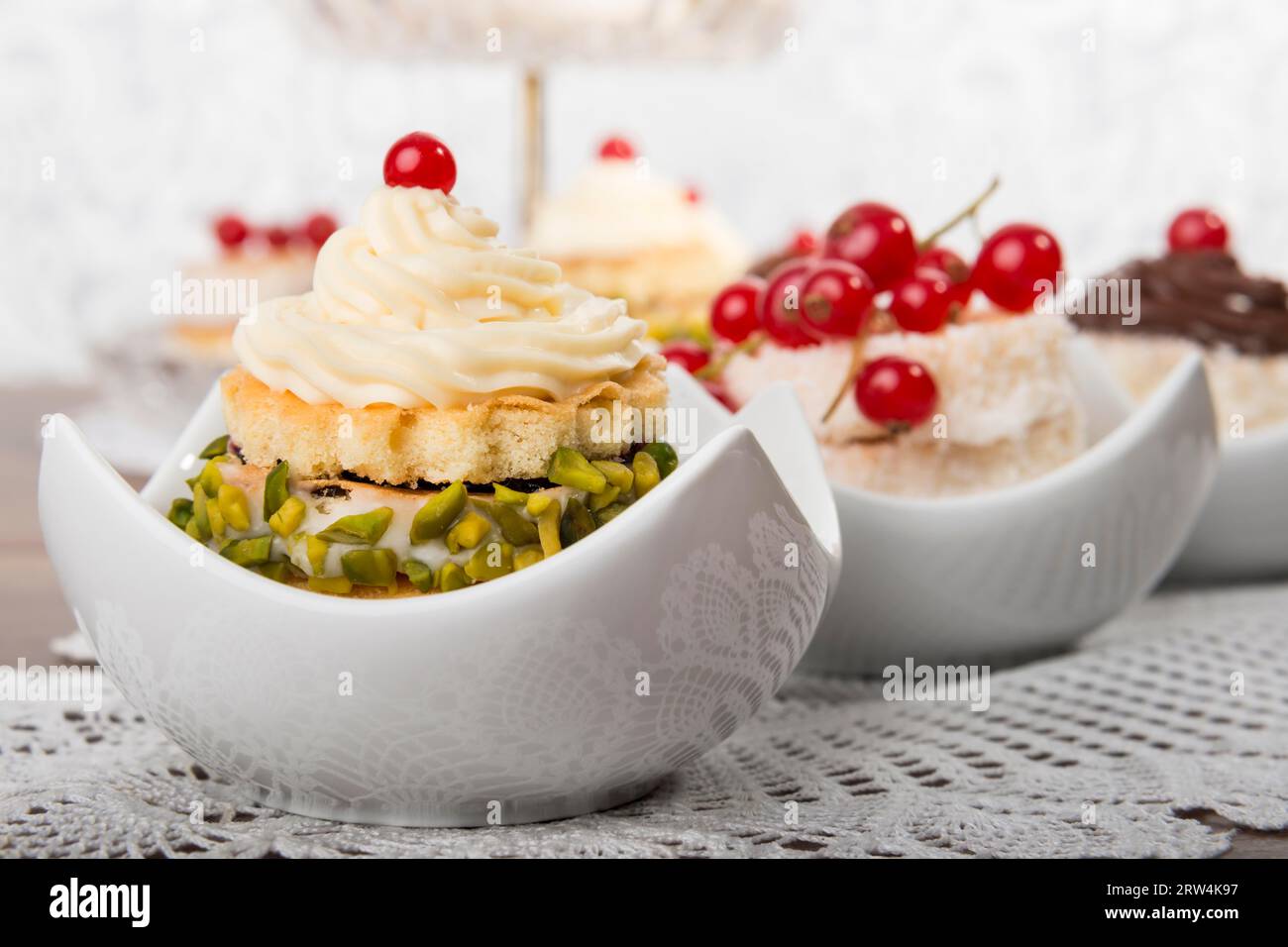 Fine pastries in small bowls in front of an etagere Stock Photo - Alamy