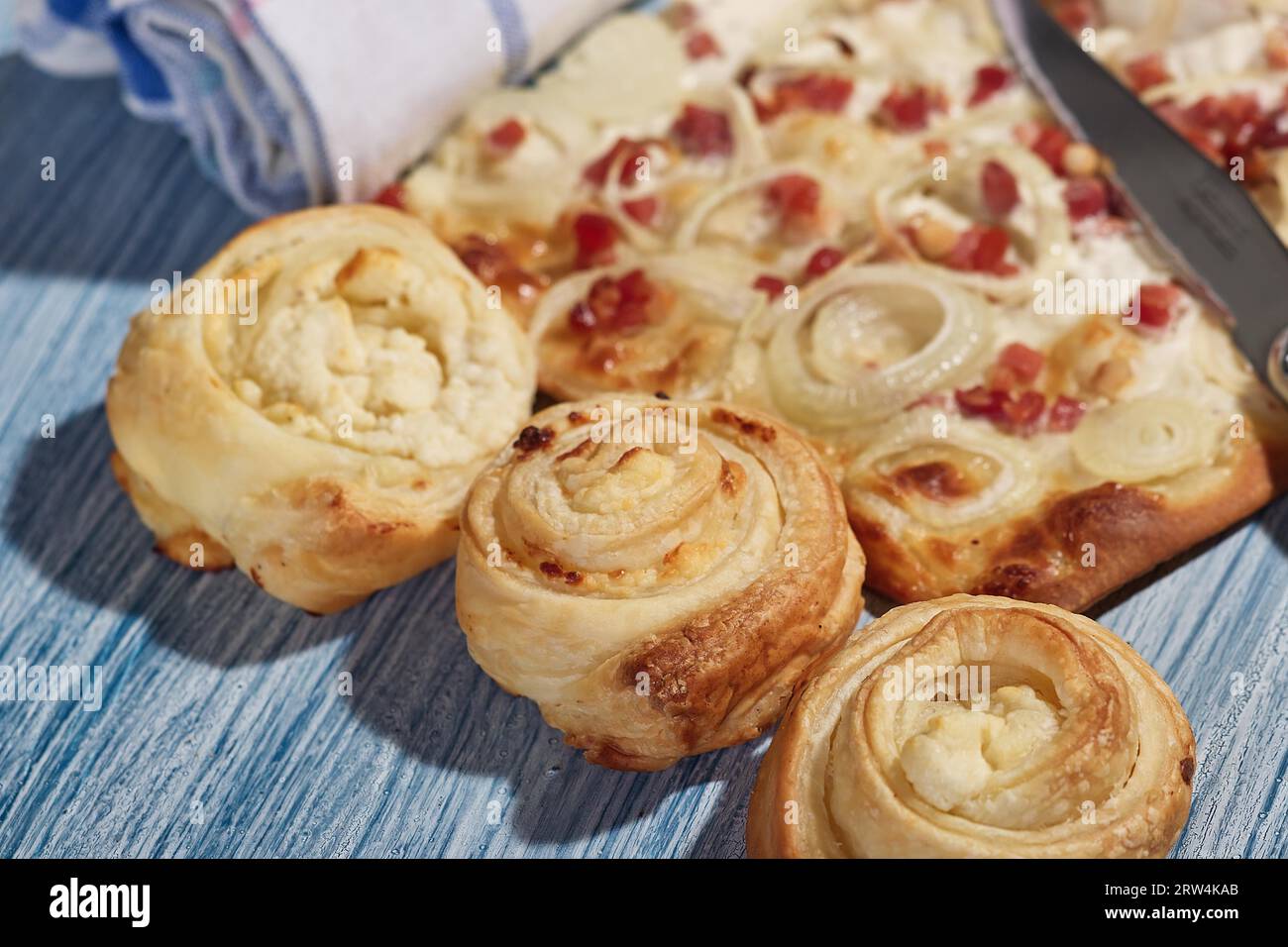 Tarte flambee and three puff pastry tarts on a rustic base Stock Photo ...