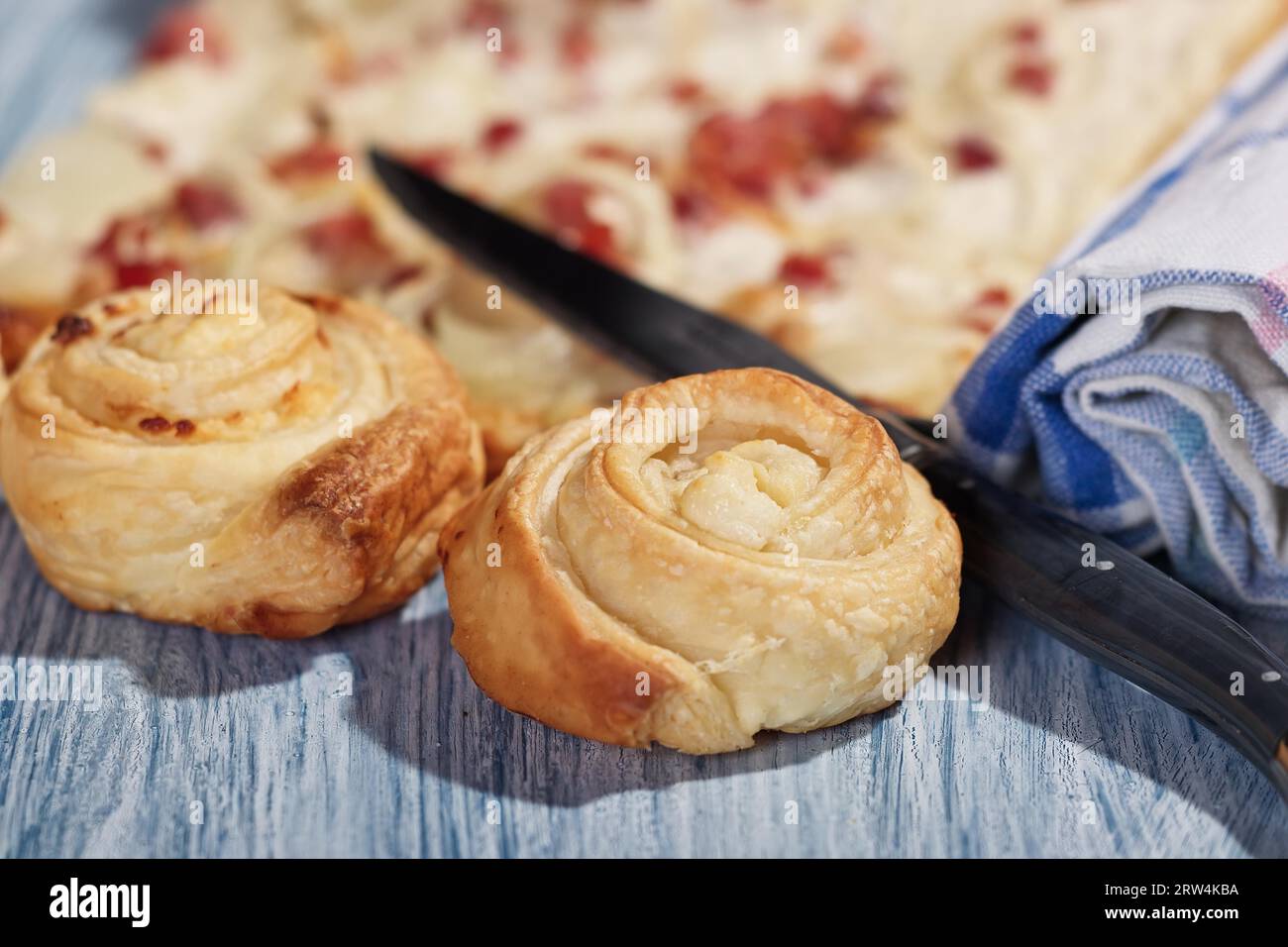 Tarte flambee and three puff pastry tarts on a rustic base Stock Photo ...