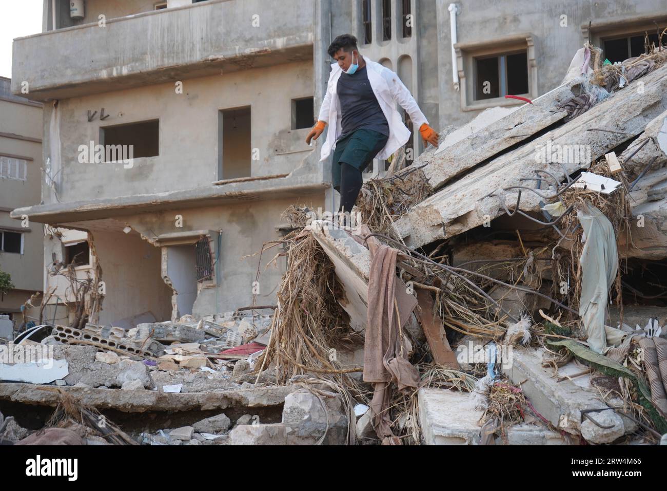 Derna, Libya. 16th Sep 2023. A rescuer works on a damaged building in ...