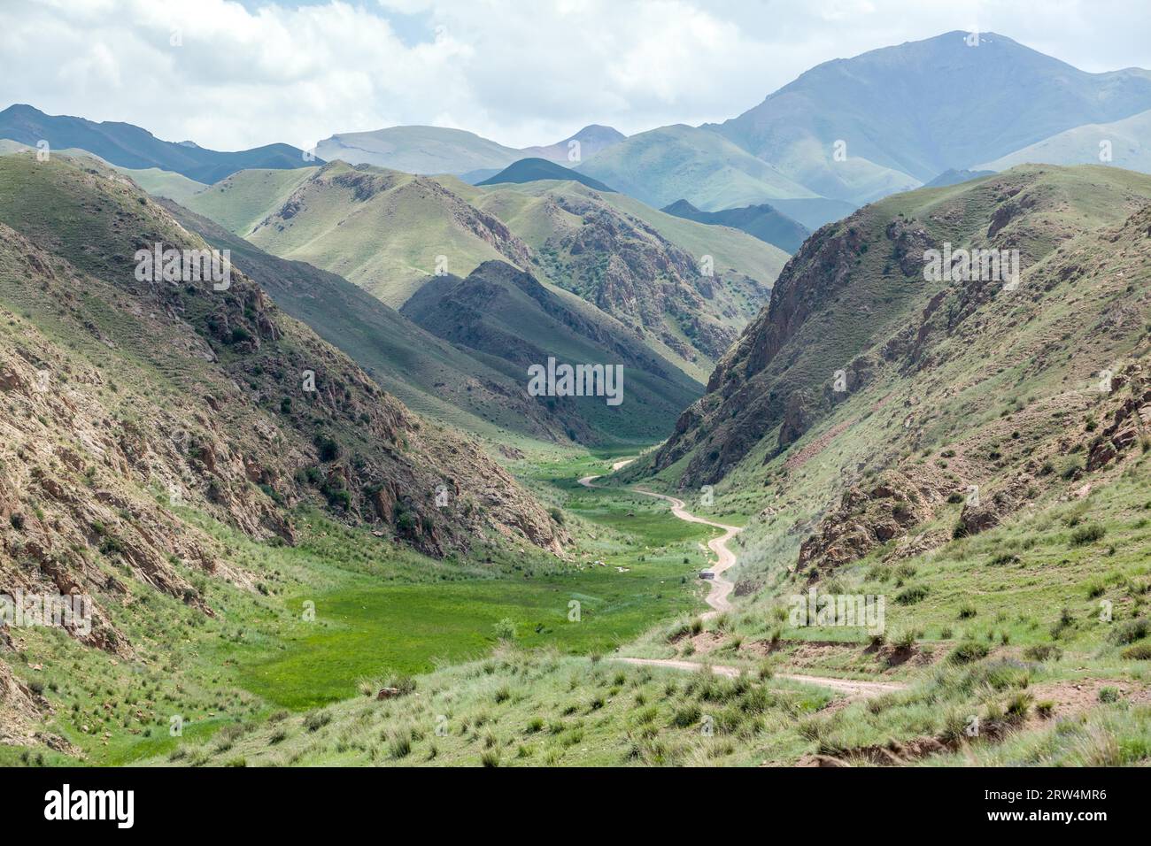 Car on dirt road in deep canyon of Tien Shan mountains, Kyrgyzstan ...