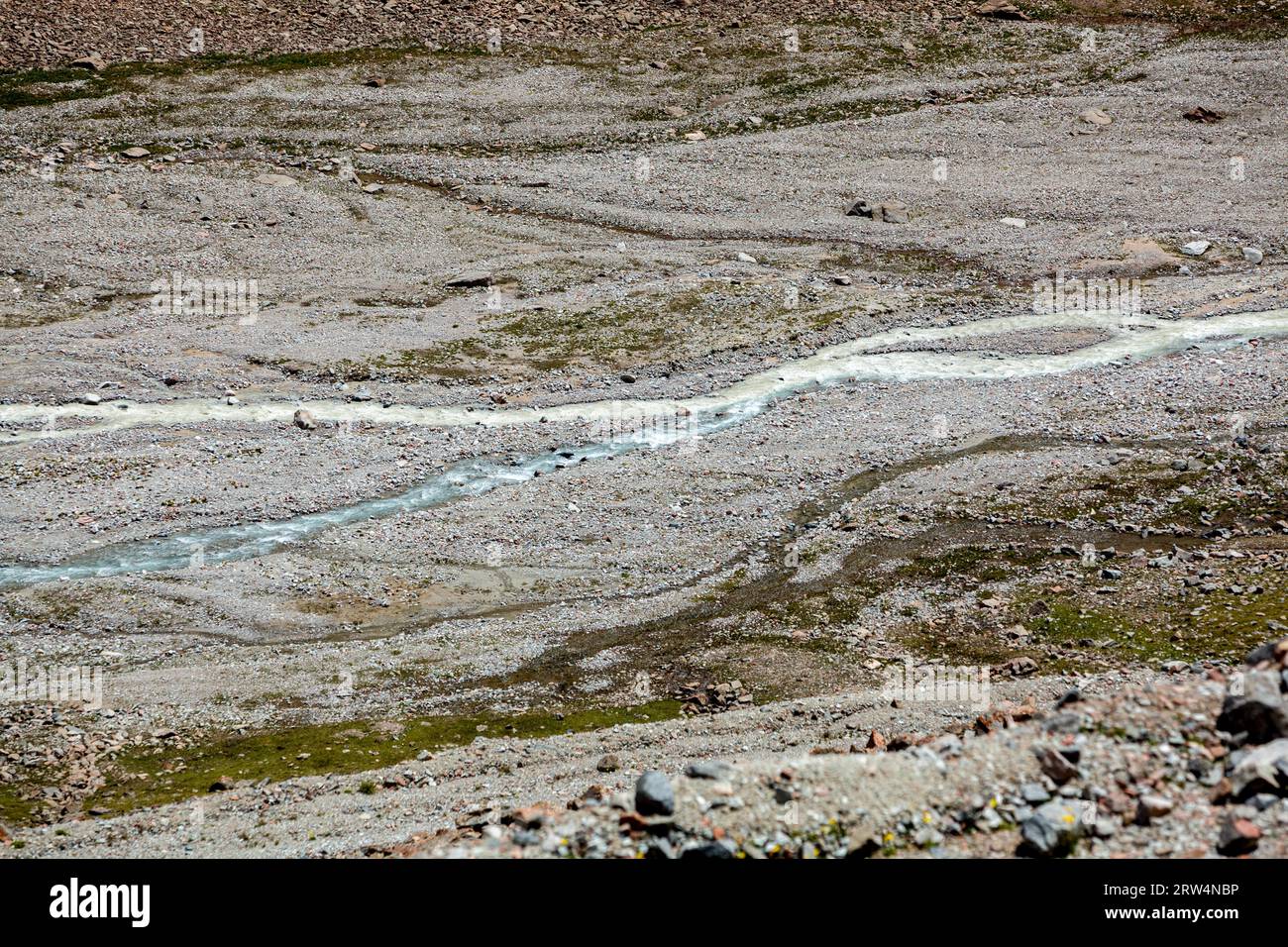 Pure and dirty rivers confluence. Kyrgyzstan Stock Photo - Alamy
