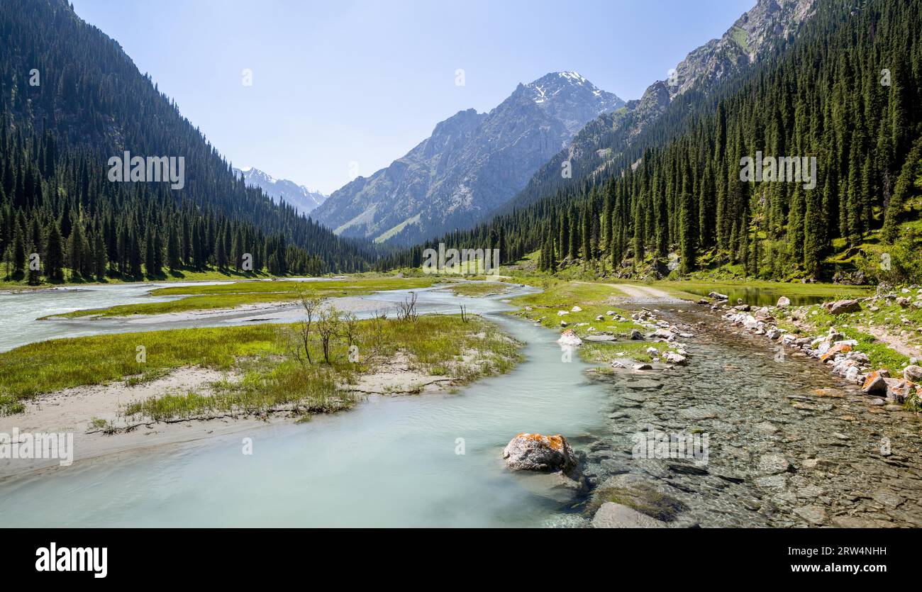 Confluence of pure and muddy rivers on mountain road in Karakol ravine ...