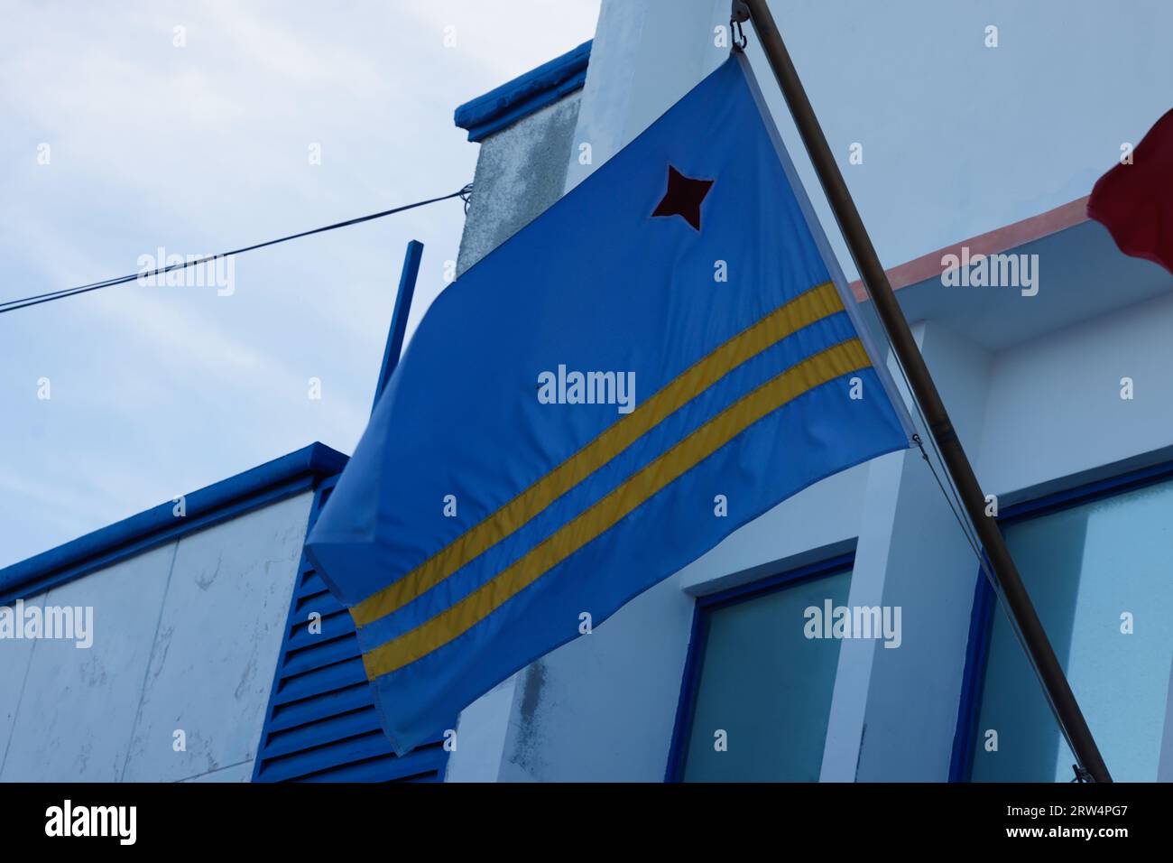 Aruba flag and blue sky with clouds Stock Photo - Alamy