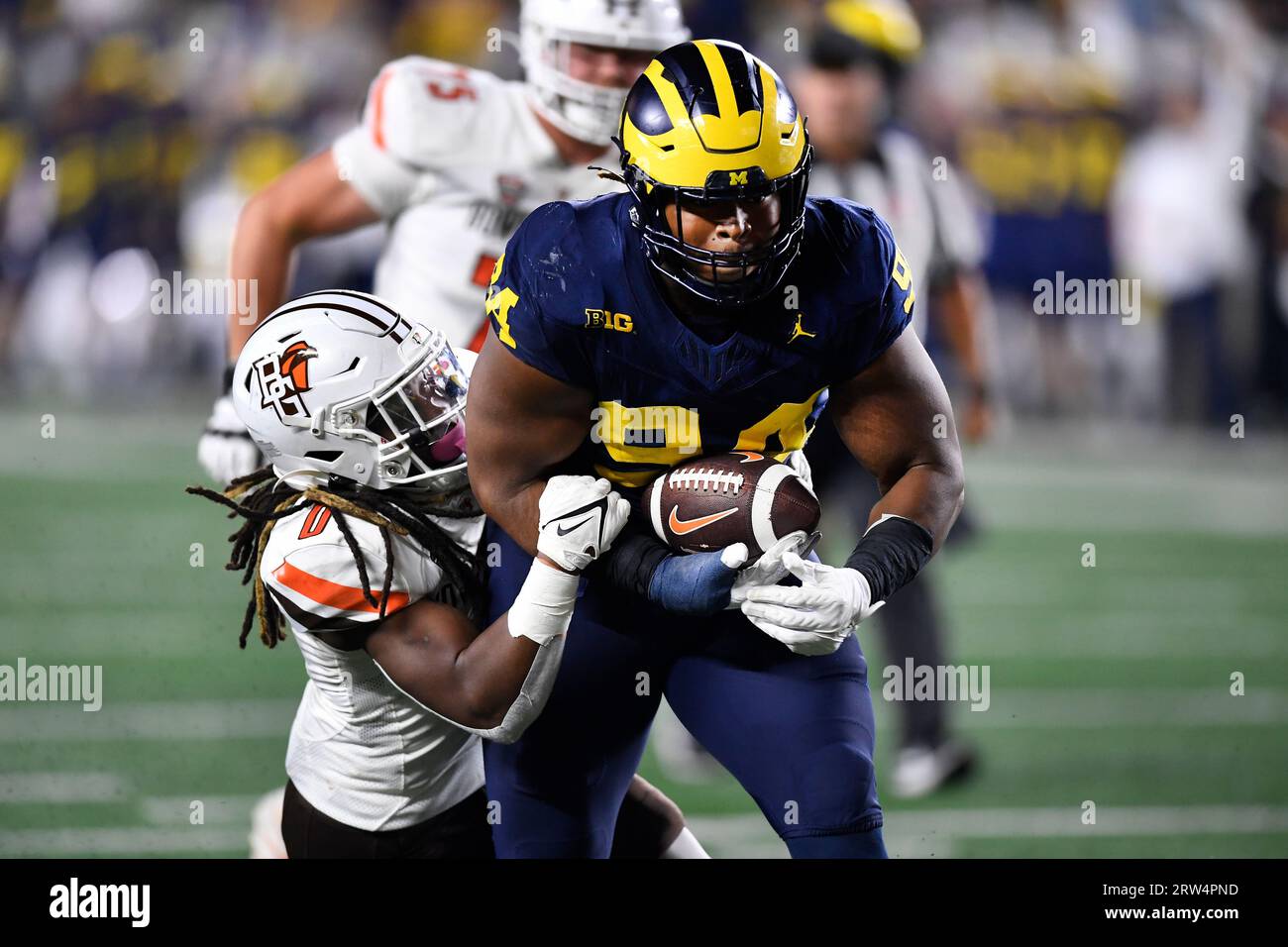 Michigan defensive lineman Kris Jenkins, right, returns an interception ...