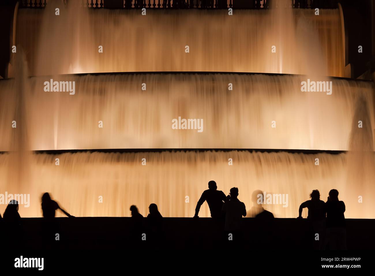 Stepped fountain and water cascades illuminated at night in Barcelona ...