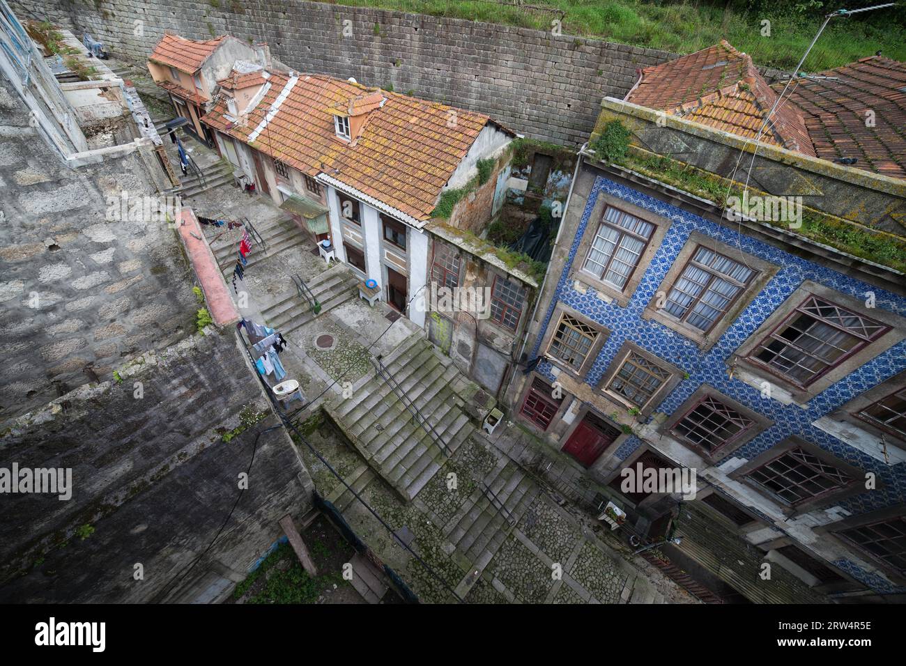 Porto in Portugal, traditional Portuguese houses along city alley with steps, looking down from ...