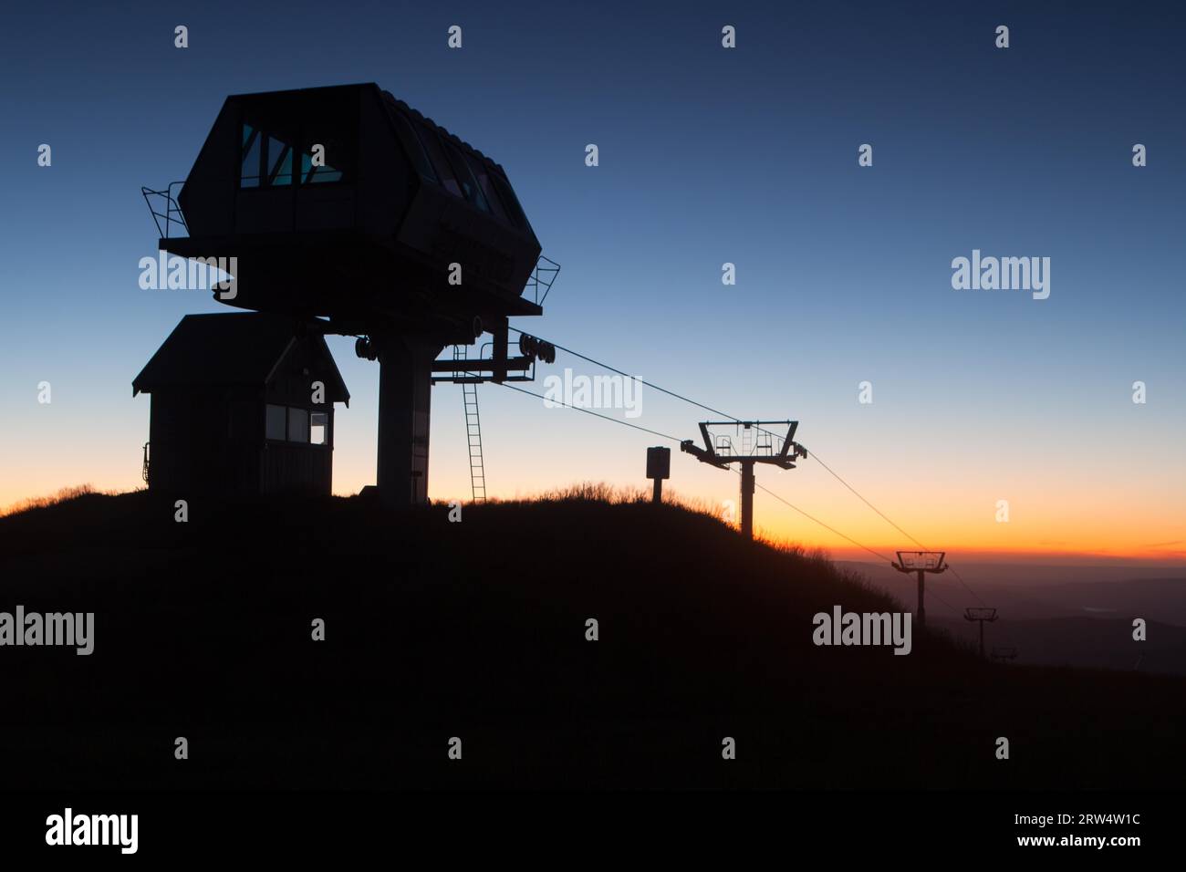 A ski lift and building under a summer starry sky at Mt Buller in the ...