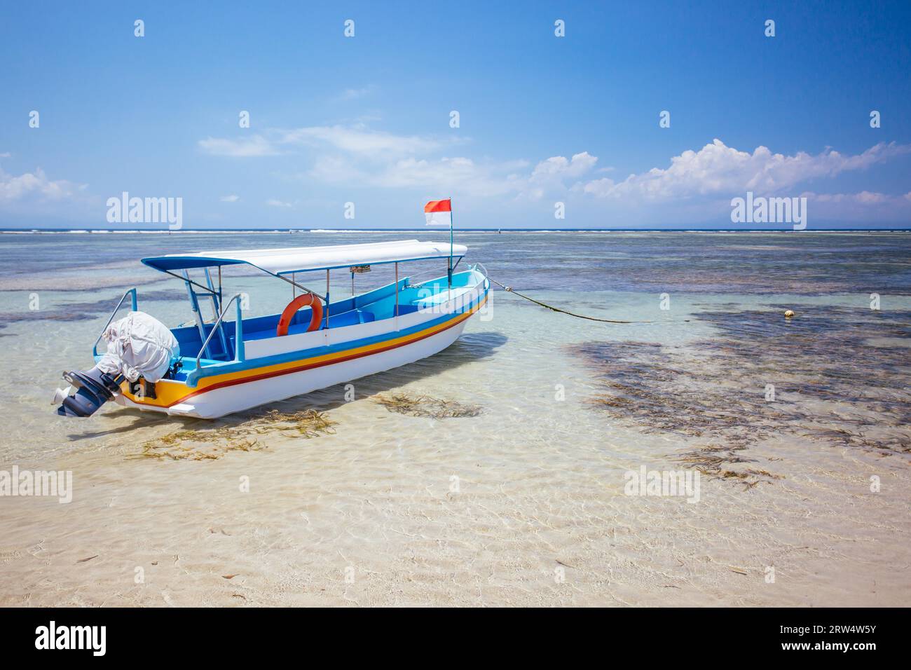 Beach scene and traditional Balinese boat on a Sanur beach in Bali ...
