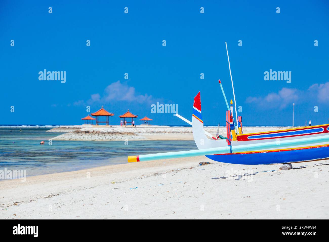 Beach scene and traditional Balinese boat on a Sanur beach in Bali ...