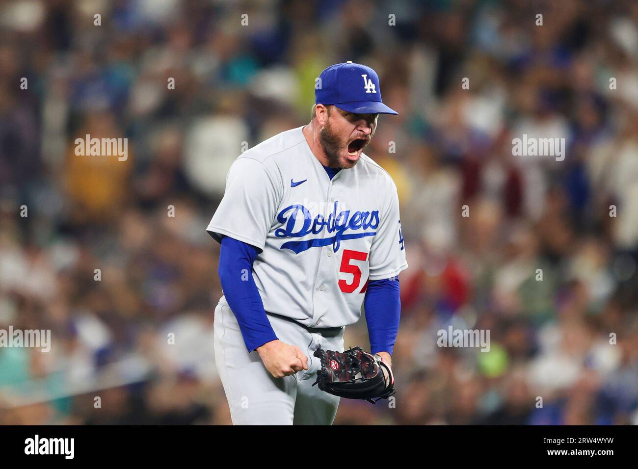 Los Angeles Dodgers relief pitcher Ryan Brasier reacts after striking ...