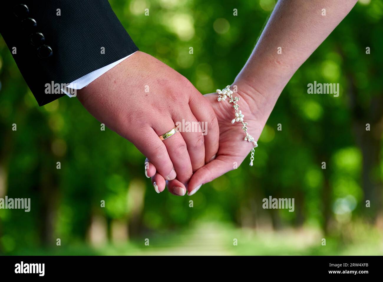 Wedding couple hand in hand Stock Photo - Alamy