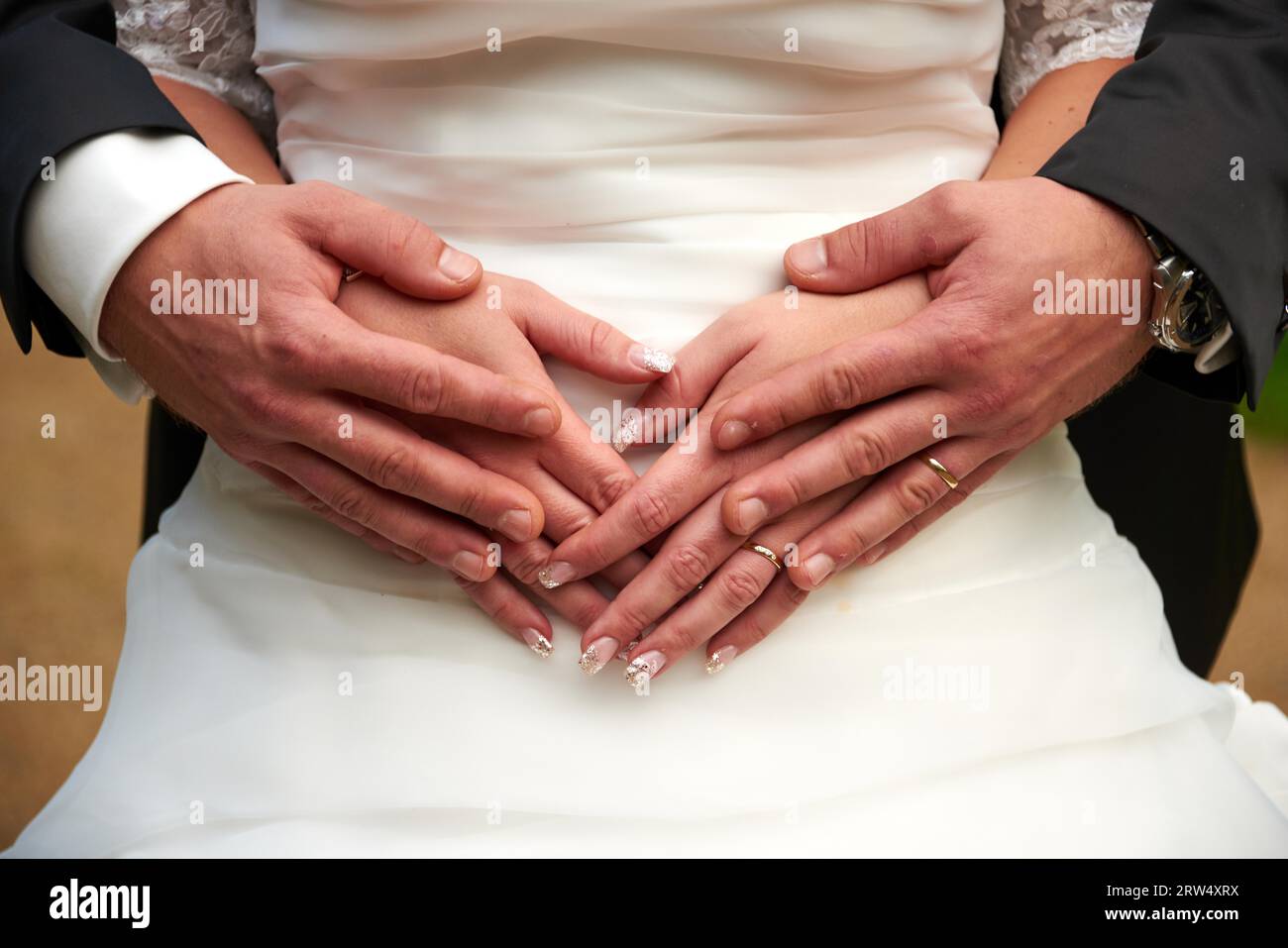 Wedding couple hand in hand Stock Photo - Alamy
