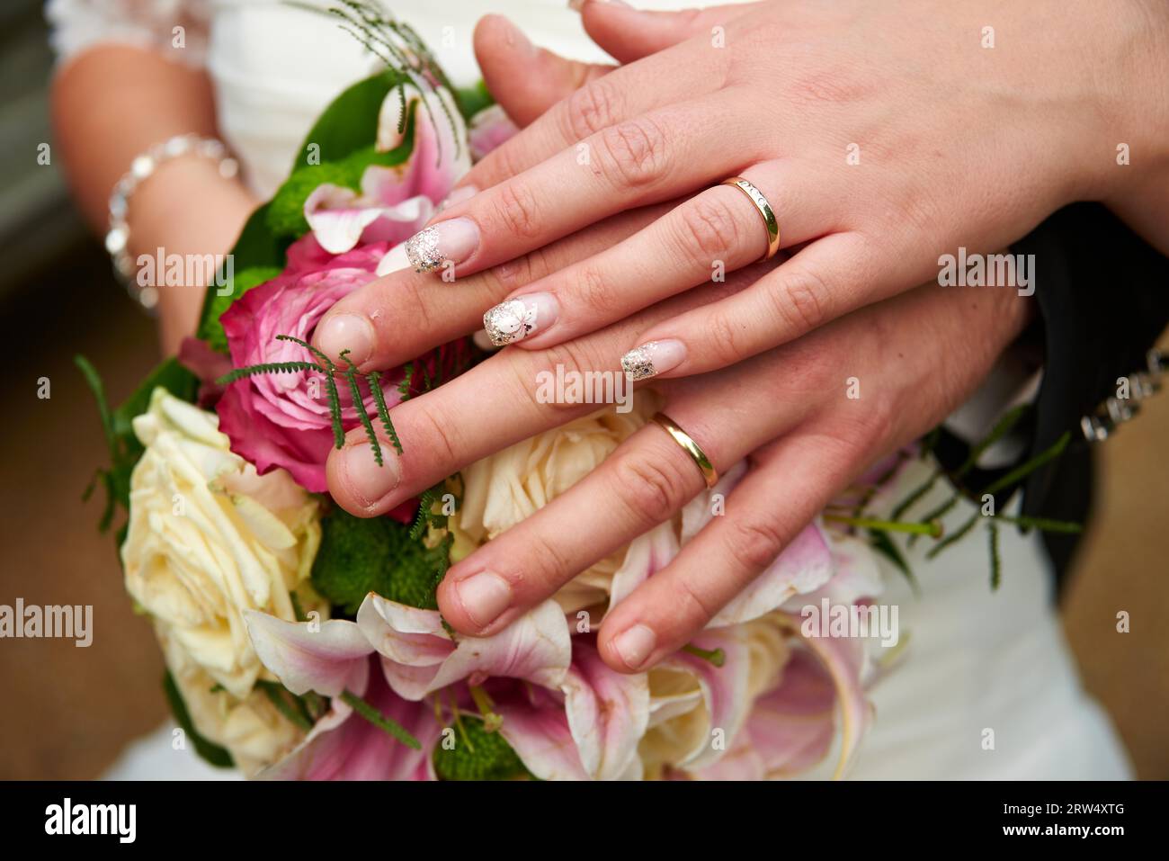 Wedding couple hand in hand Stock Photo - Alamy