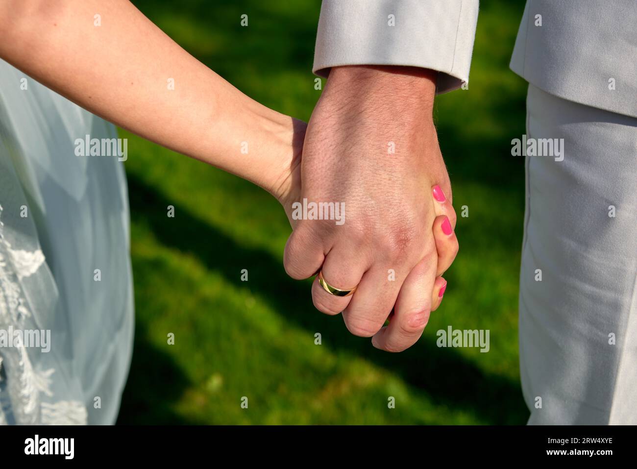 Wedding couple hand in hand Stock Photo - Alamy