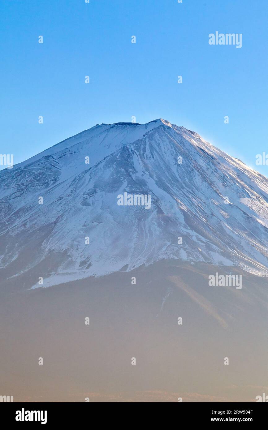 The majestic Mount Fiji peak blanketed in a layer of fresh white snow ...