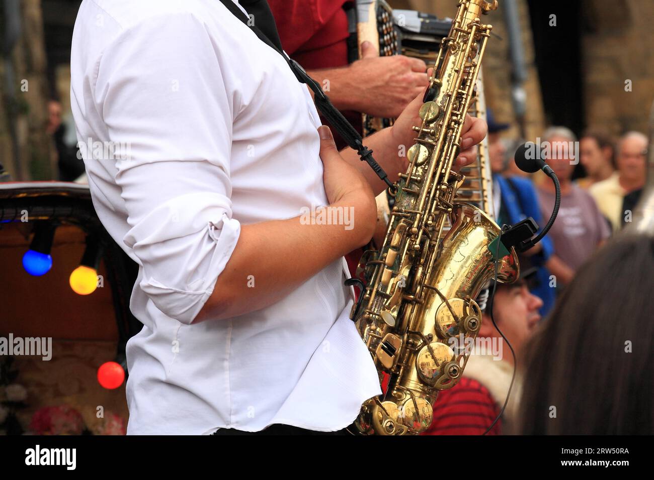 Street concert with some listeners Stock Photo - Alamy