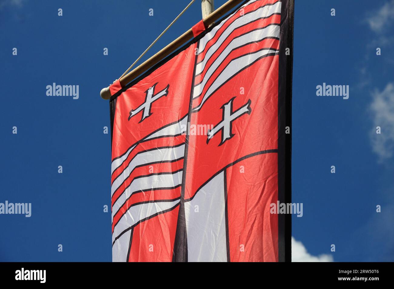 Flag with medieval symbols, cut-out, background blue sky and white ...