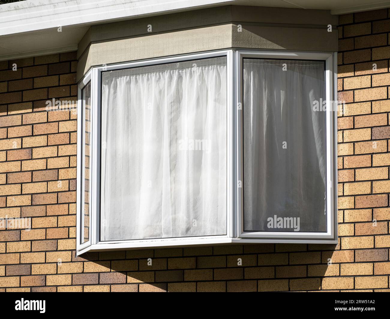 Bay window on brick wall Stock Photo - Alamy