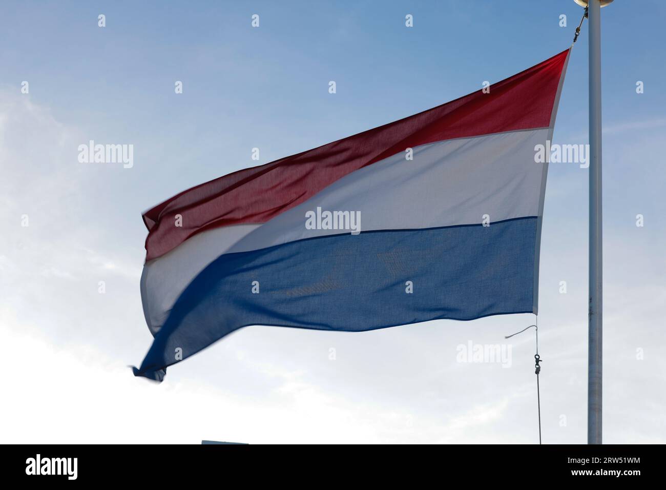 Netherlands flag isolated on the blue sky with clipping path. close up ...