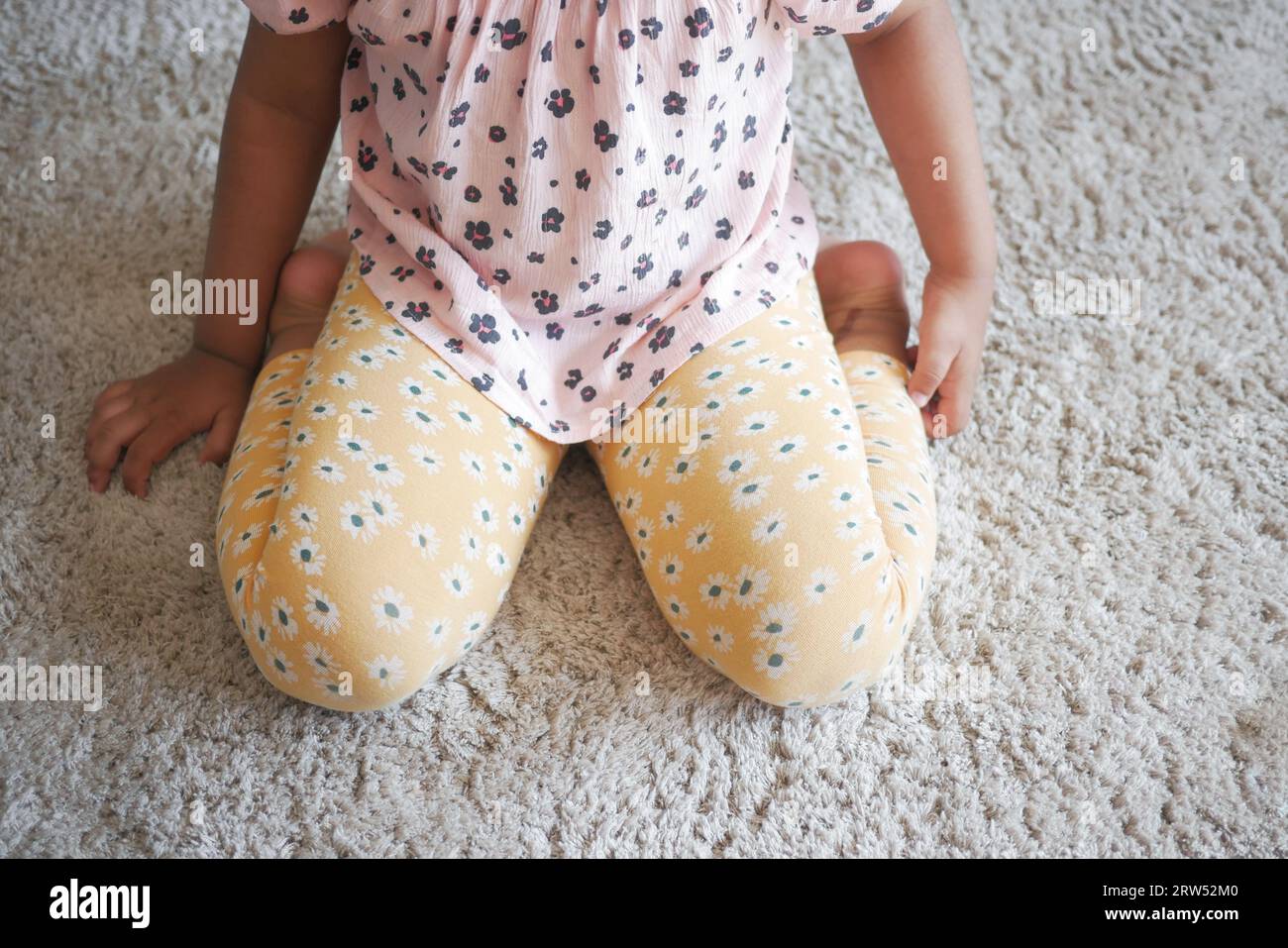 child sitting W posture on the floor Stock Photo - Alamy